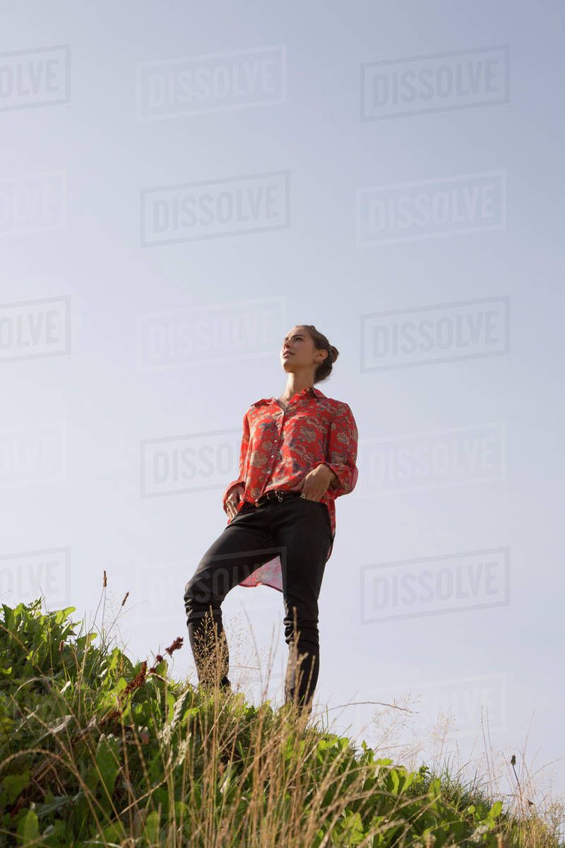 Young woman standing in park, low angle view - Royalty-free Stock Photo ...