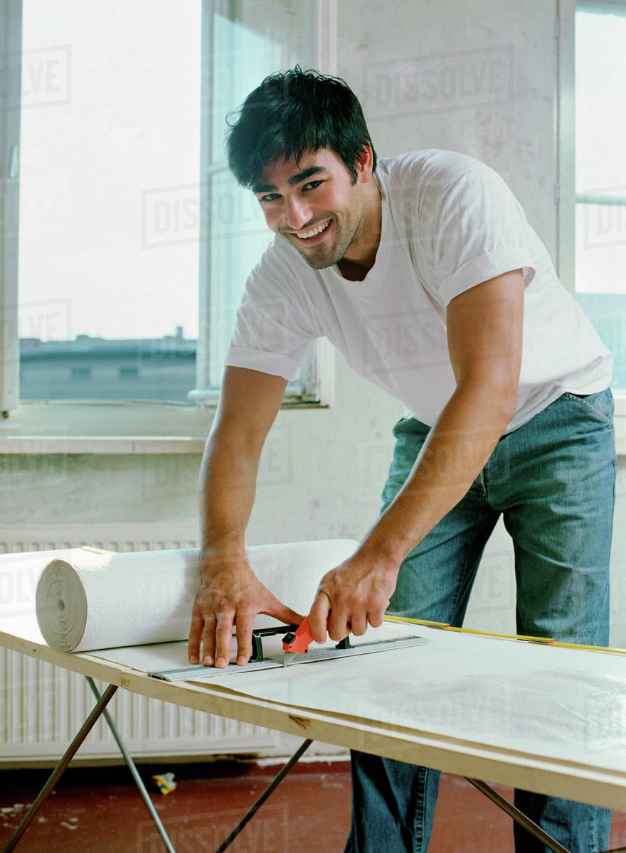 A man cutting paper with work tool, portrait - Royalty-free Stock Photo ...
