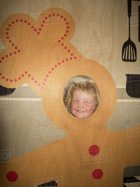 Happy cute boy in gingerbread man costume at home - Stock Photo - Dissolve