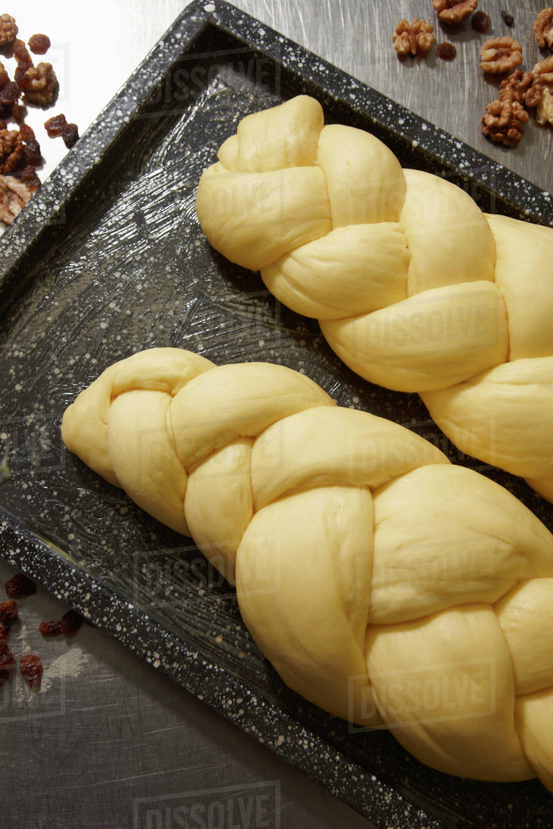 Two loaves of braided bread waiting to be baked - Stock Photo - Dissolve