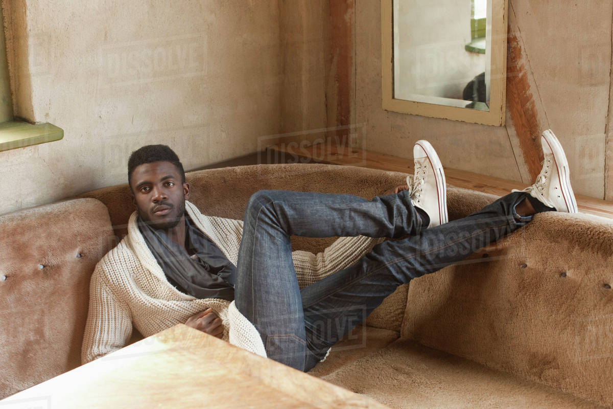 A stylish man reclining in a booth - Royalty-free Stock Photo | Dissolve