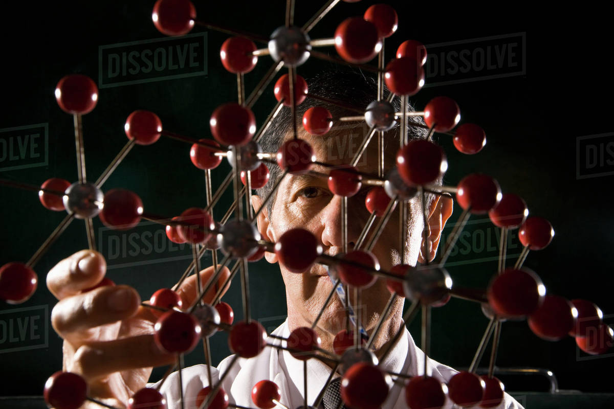 A scientist holding a molecular structure model - Stock Photo - Dissolve