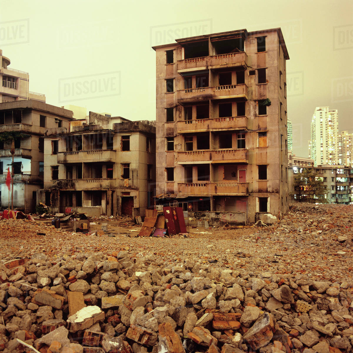 Abandoned buildings and rubble with modern high-rise buildings in ...