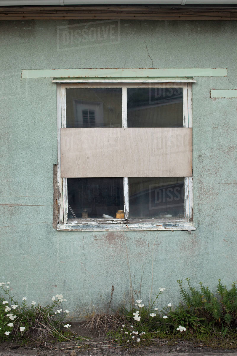 A boarded up window - Stock Photo - Dissolve