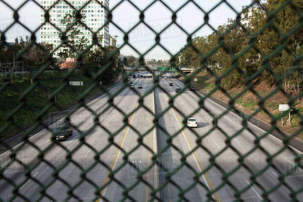 A highway seen through a chain-link fence - Royalty-free Stock Photo ...