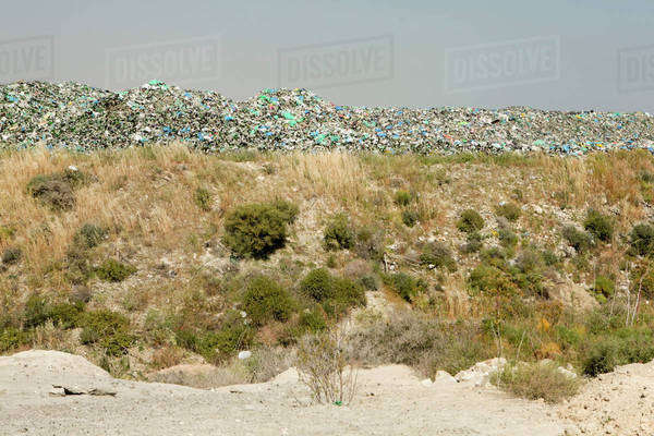Garbage heap and field against sky - Royalty-free Stock Photo | Dissolve