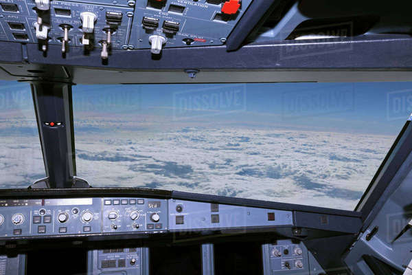 Cloudy sky seen through of airplane windshield - Stock Photo - Dissolve