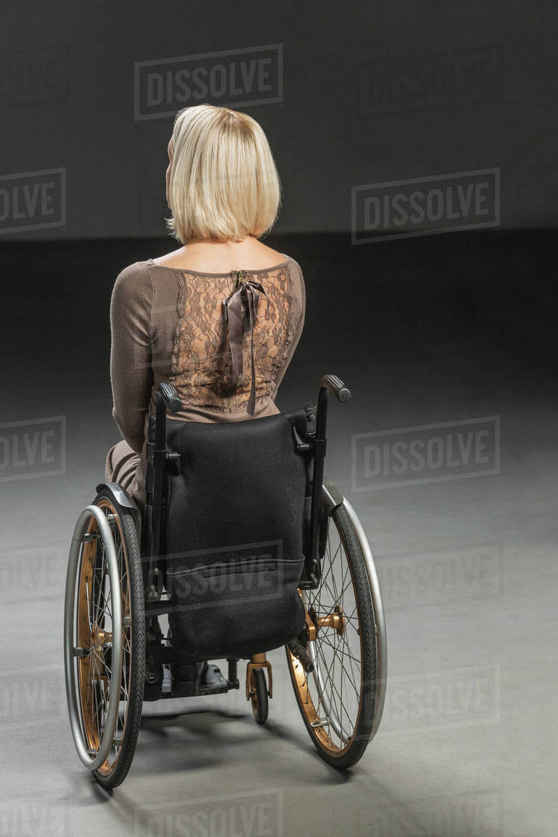 Rear view of disabled woman in wheelchair - Royalty-free Stock Photo ...