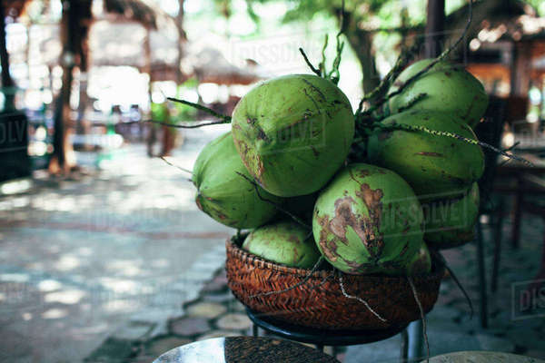 Fresh coconuts in basket outdoors - Royalty-free Stock Photo | Dissolve