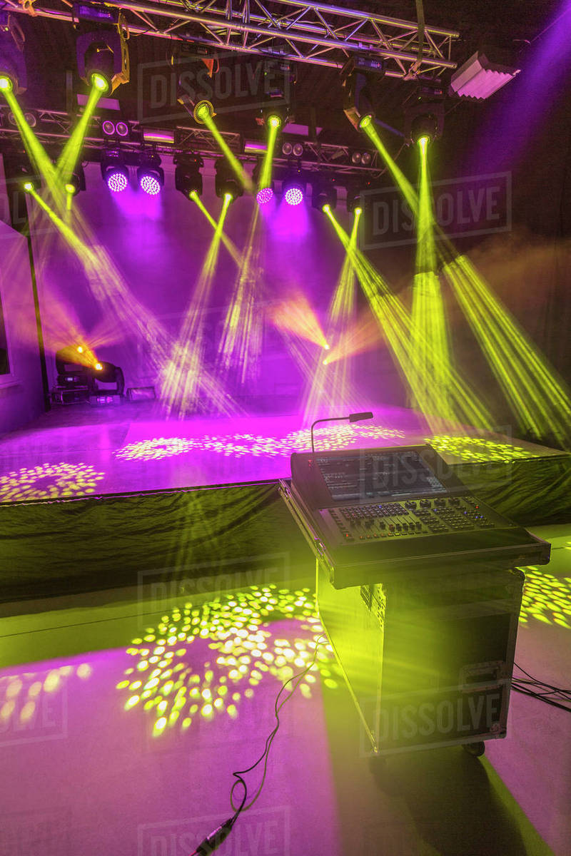 Sound mixer in front of illuminated stage in studio - Royalty-free ...