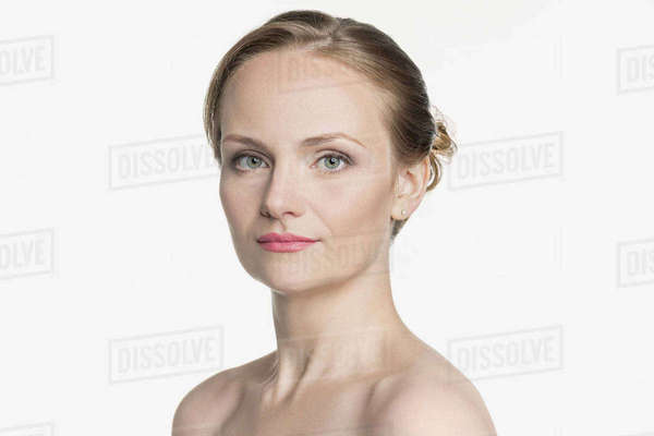 Portrait of shirtless beautiful woman standing against white background ...