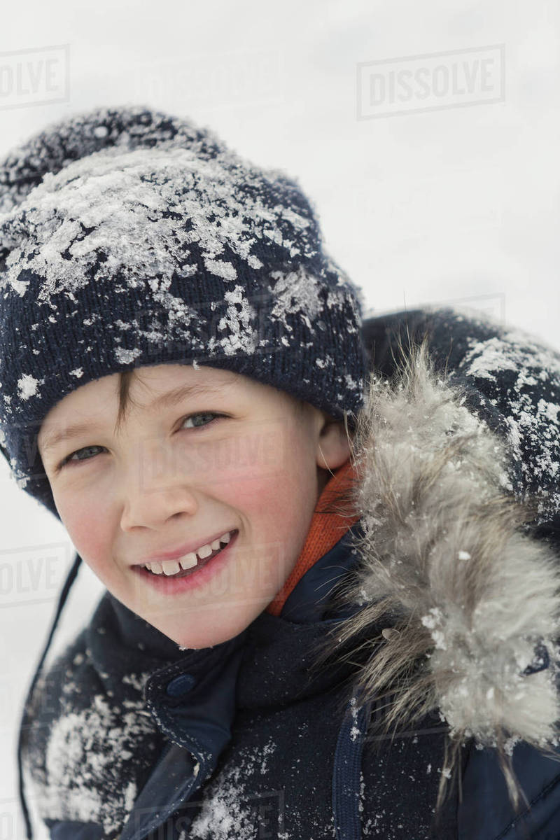 Portrait of happy boy in winter wear covered with snow - Royalty-free ...