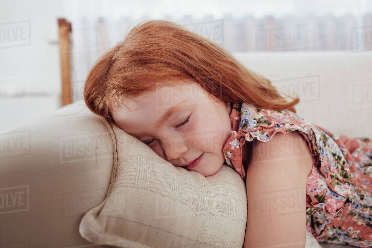 Cute girl sleeping on sofa at home - Royalty-free Stock Photo | Dissolve