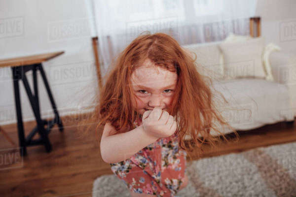 Portrait of happy girl dancing in living room at home - Royalty-free ...