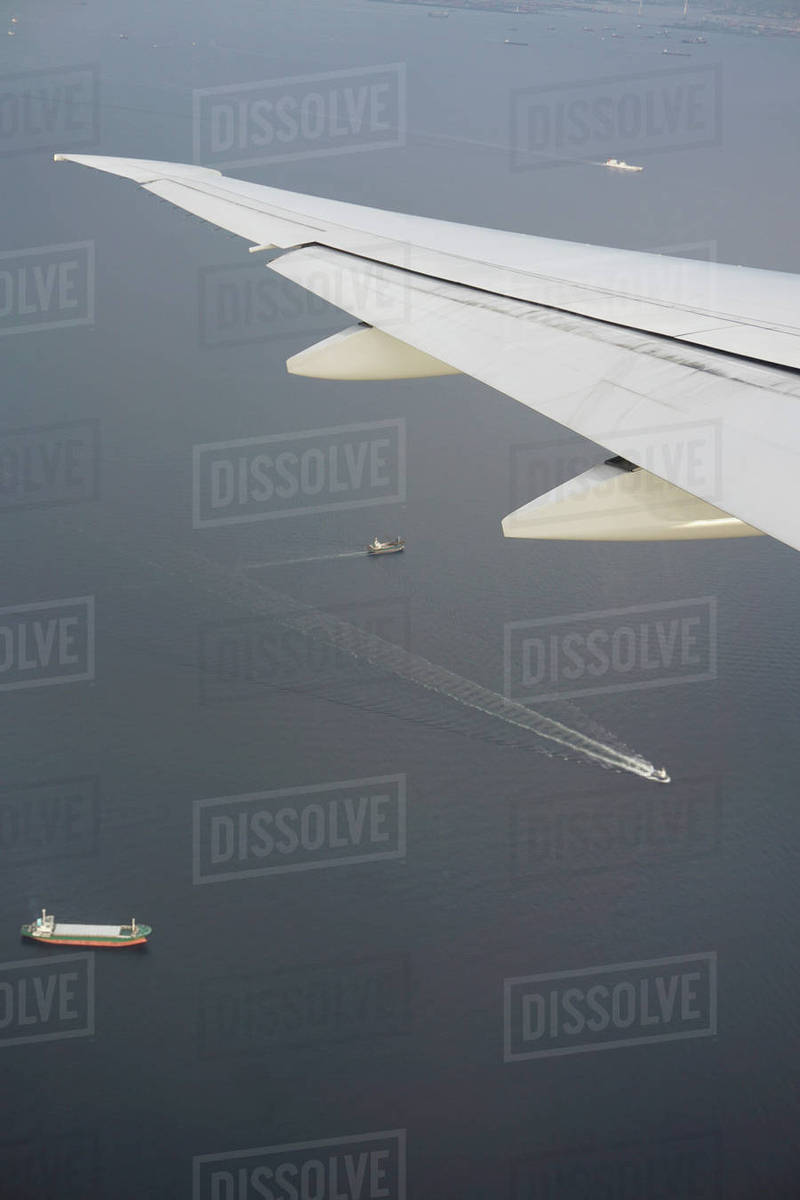 Cropped image of aircraft wing over sea, Tokyo, Japan - Royalty-free ...