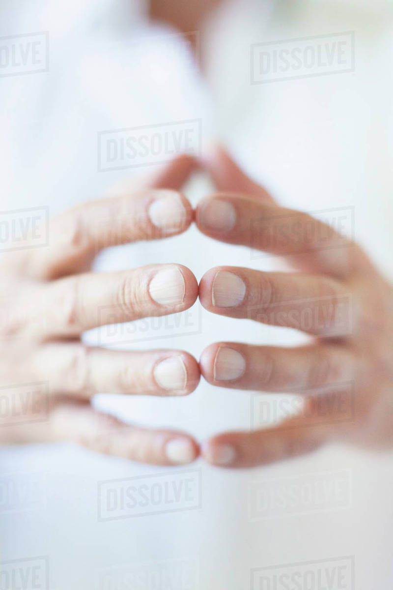 Midsection of man touching fingers - Royalty-free Stock Photo | Dissolve