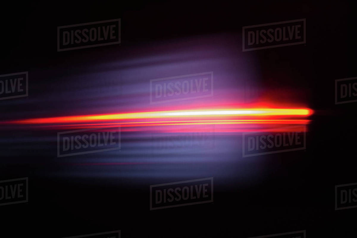 Close-up of abstract red light trail against black background - Stock ...