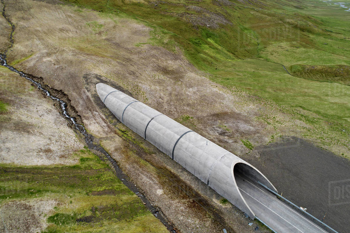 Aerial view of tunnel through landscape, Iceland - Stock Photo - Dissolve