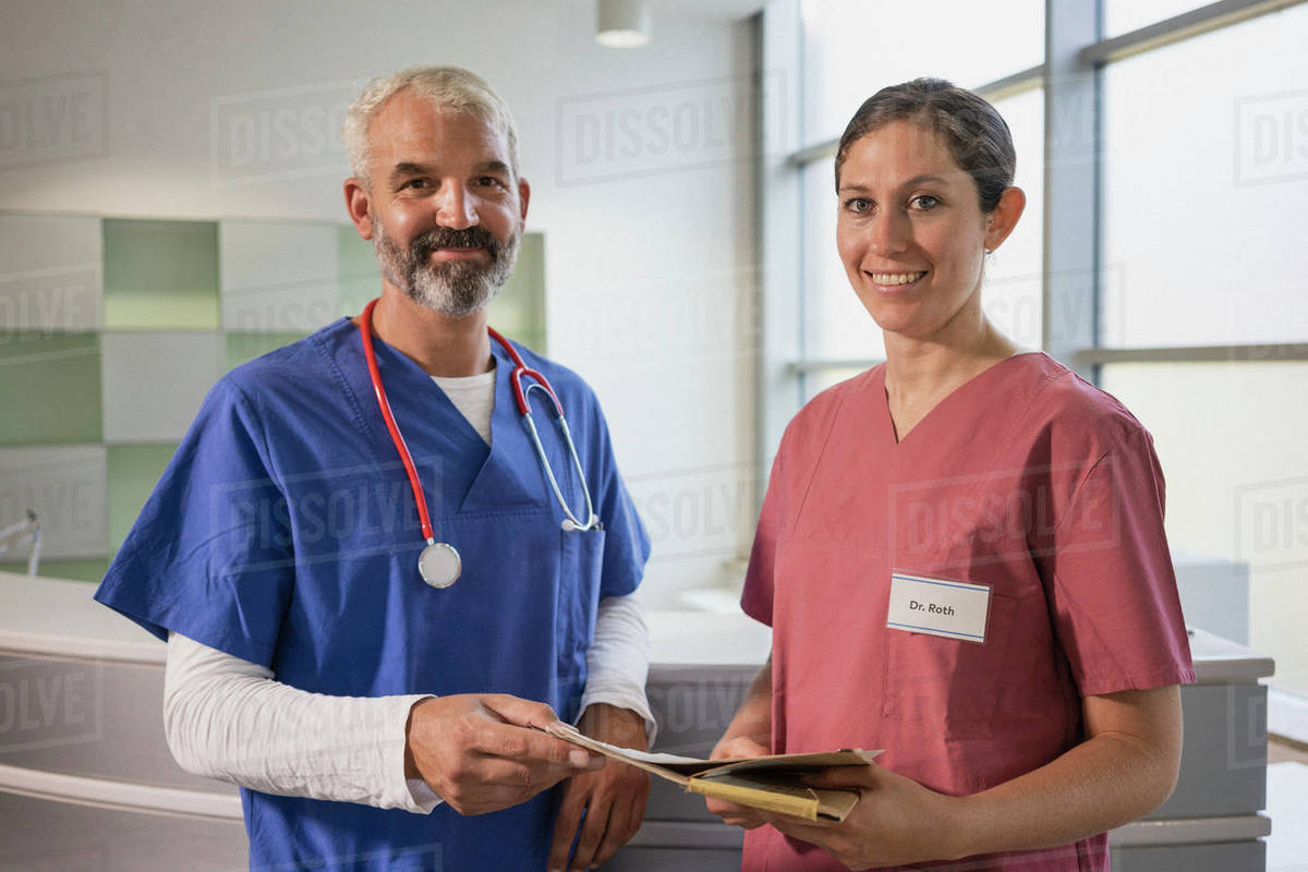 Portrait confident doctors with medical record in hospital - Royalty ...