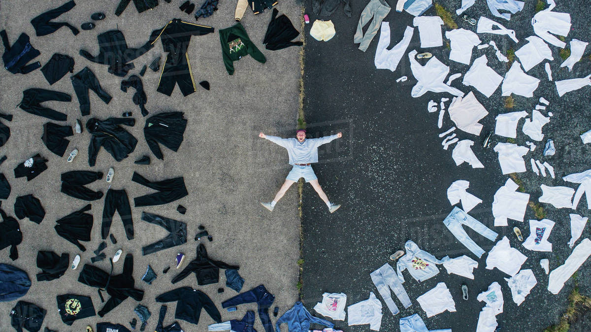 Knolling portrait man surrounded by color coded clothing wardrobe ...
