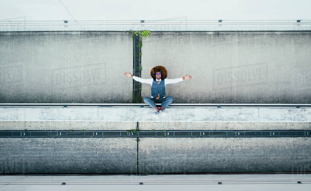 View from above portrait exuberant young man on urban ledge - Stock ...