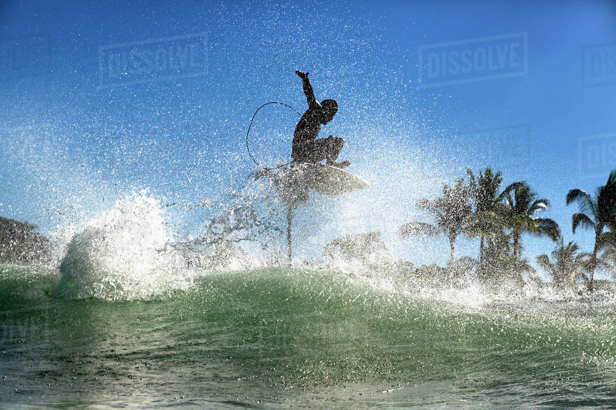 Male surfer catching air above ocean wave, Sayulita, Nayarit, Mexico ...