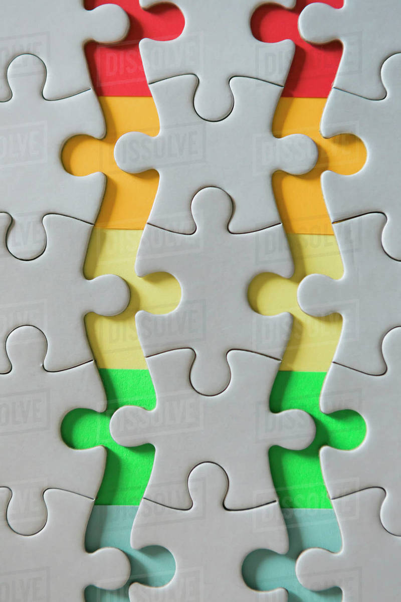 Rainbow edges of disconnected jigsaw puzzle pieces - Stock Photo - Dissolve