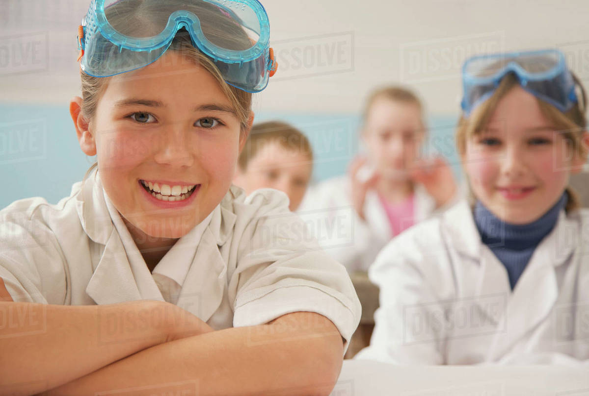 Portrait happy junior high school students in science goggles - Royalty ...