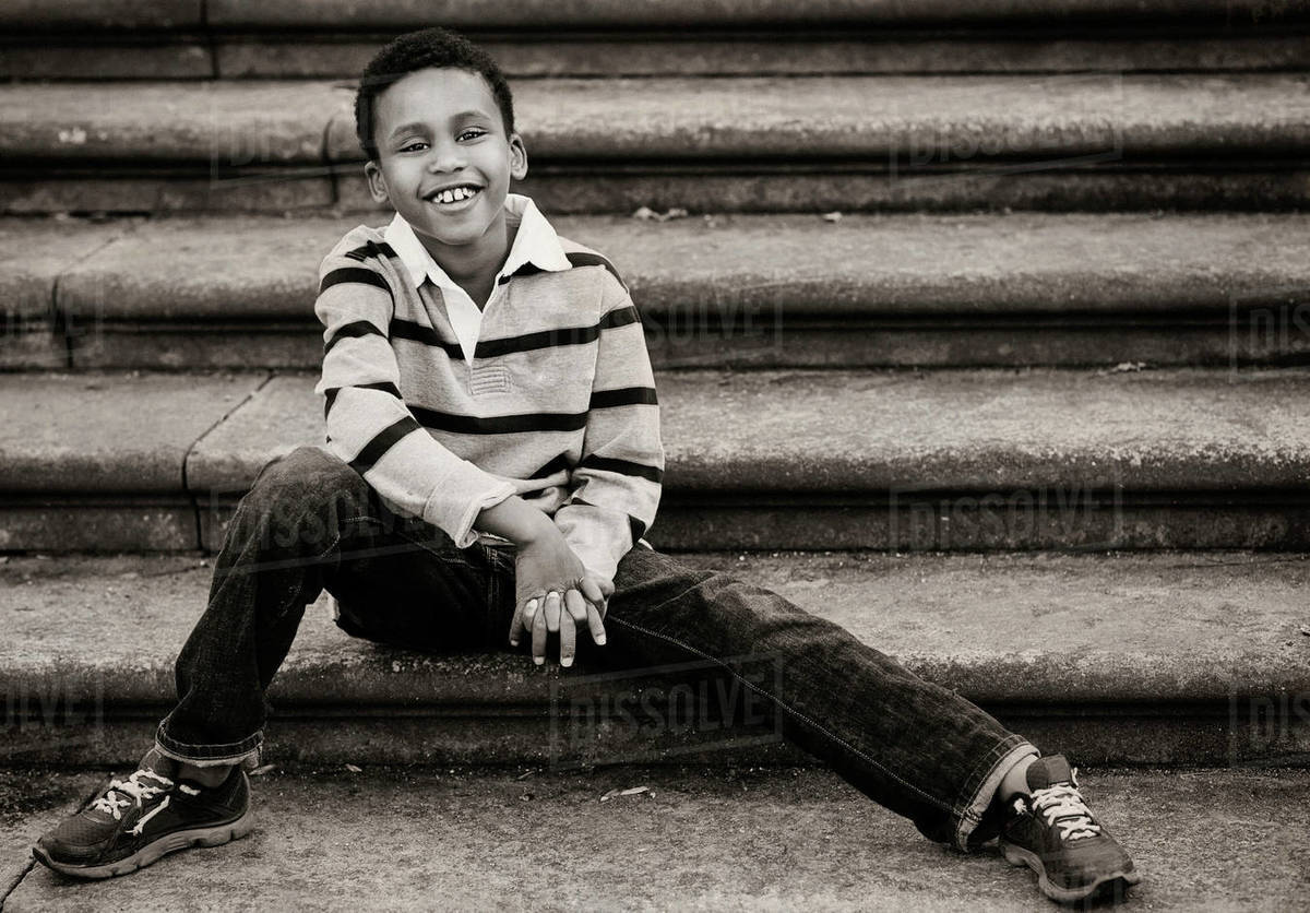 Portrait confident boy sitting on urban steps - Royalty-free Stock ...