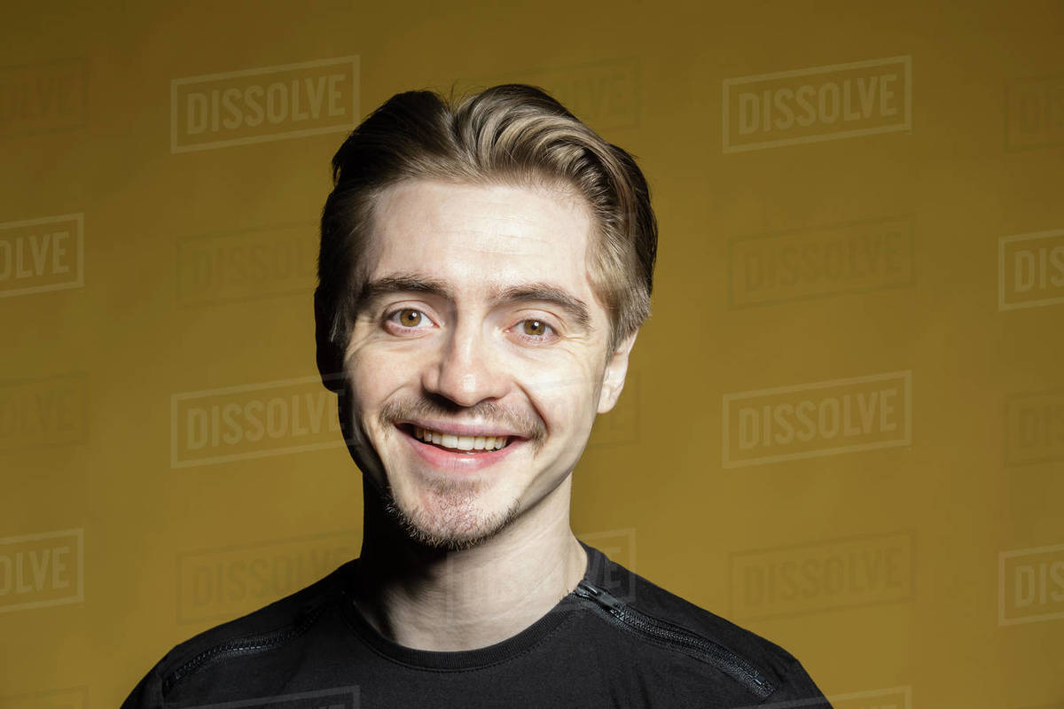 Portrait happy young man on yellow background - Stock Photo - Dissolve