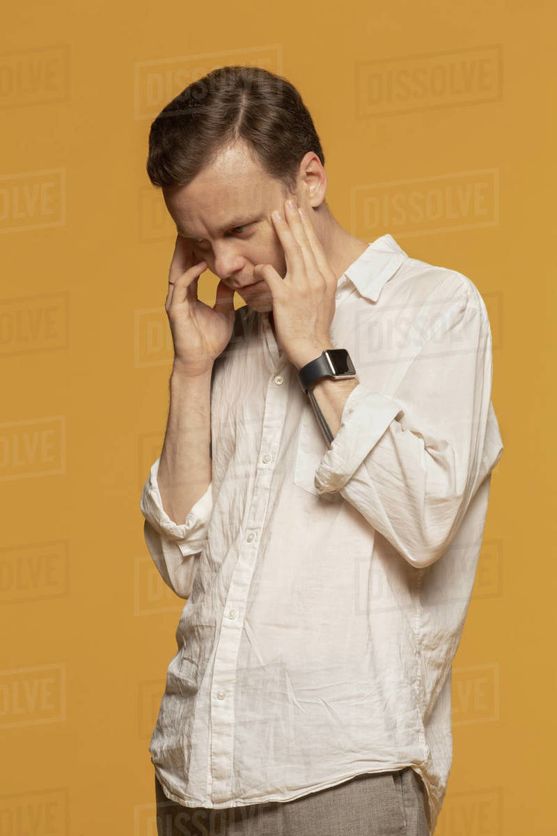 Thoughtful man with head in hands - Royalty-free Stock Photo | Dissolve