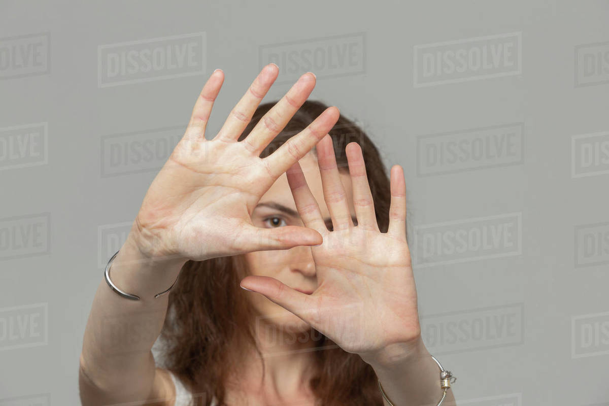 Woman covering face with hands - Royalty-free Stock Photo | Dissolve