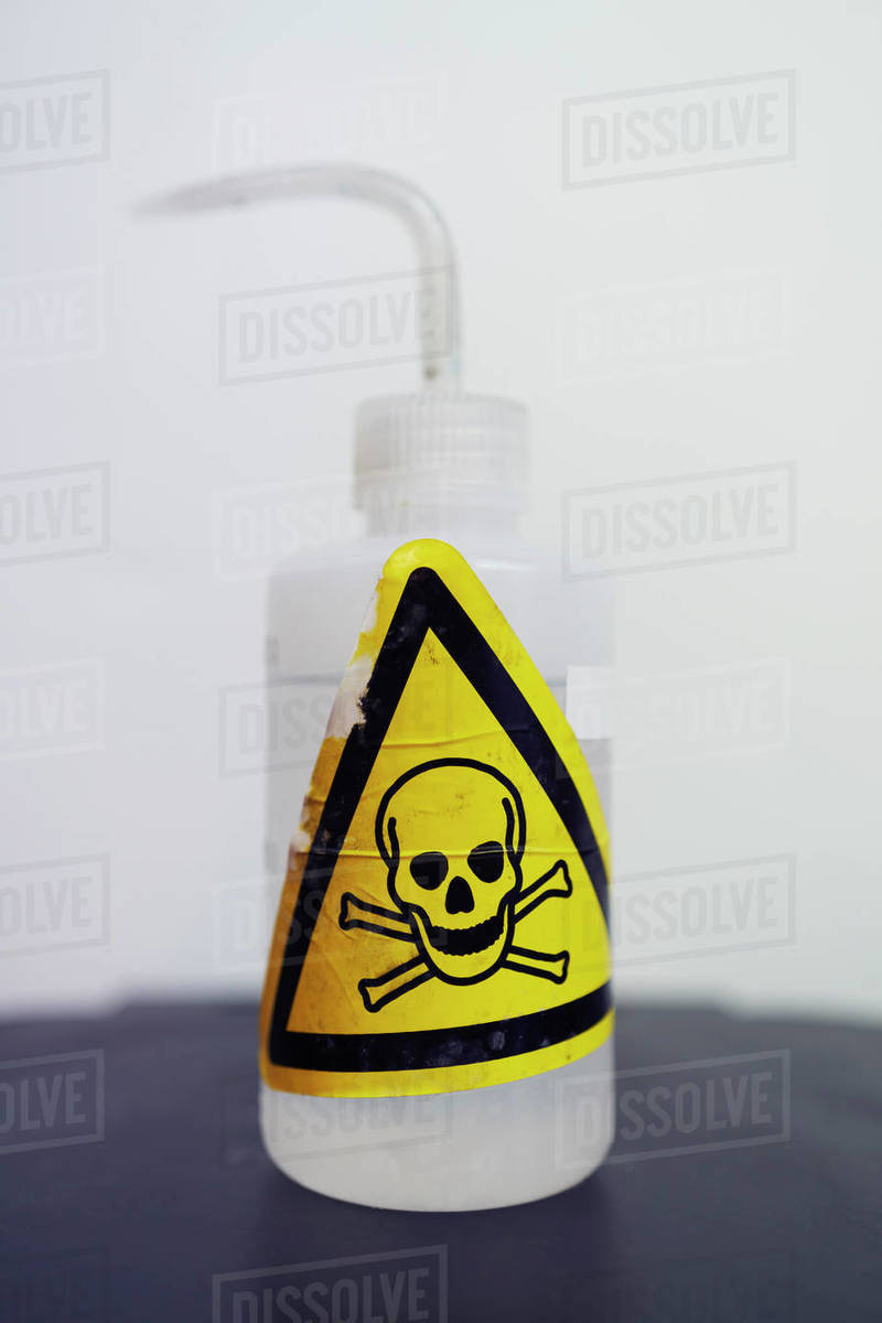 Close up biohazard label on bottle - Royalty-free Stock Photo | Dissolve