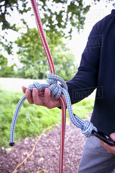 Close up of climber hands holding and checking climbing rope - Stock ...