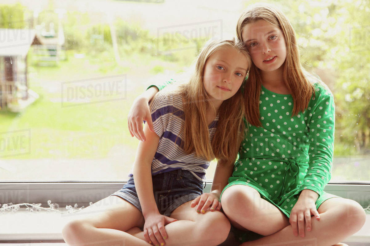 Two Young Girls Sitting on Window Sill - Royalty-free Stock Photo ...