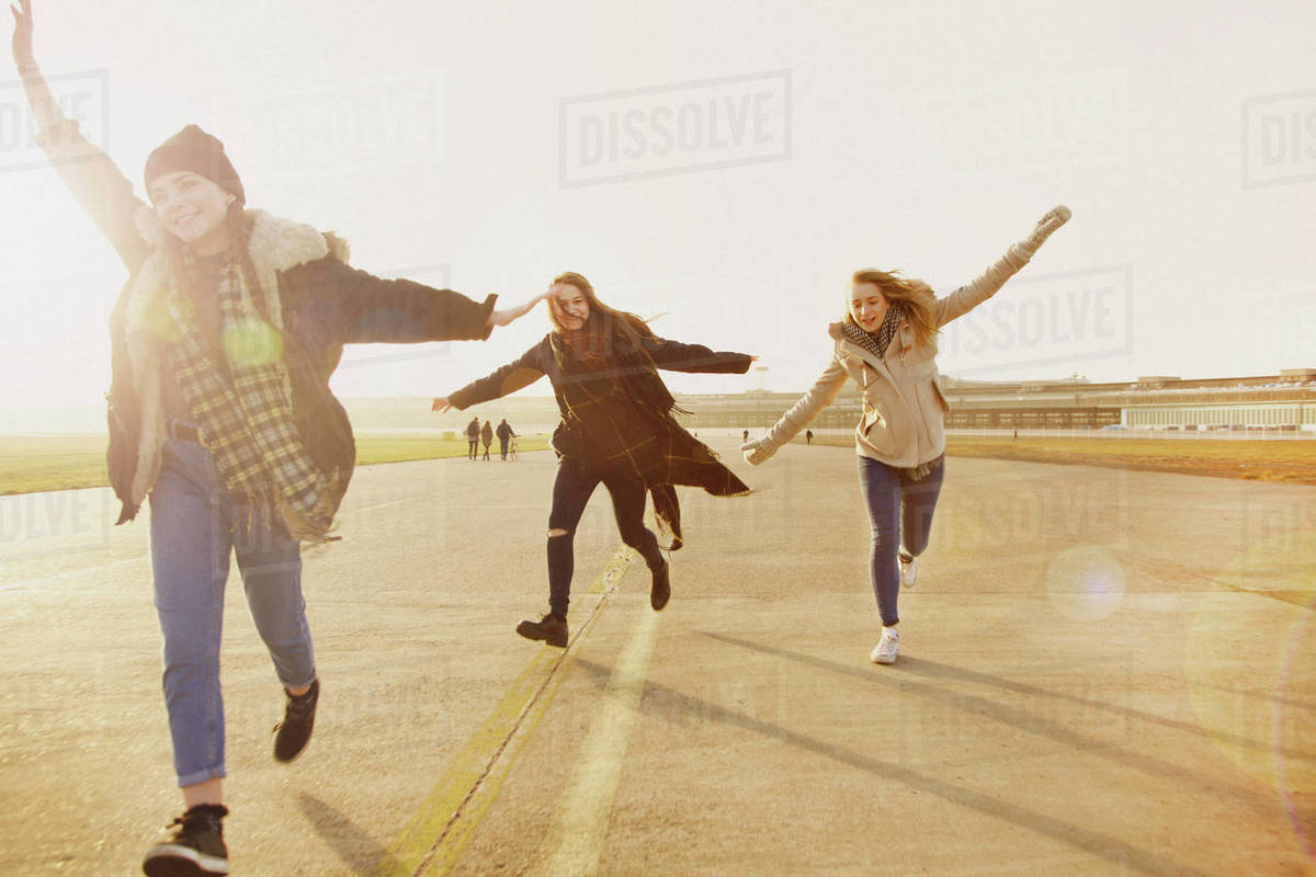 Teenage Girls Running with Arms Outstretched - Royalty-free Stock Photo ...
