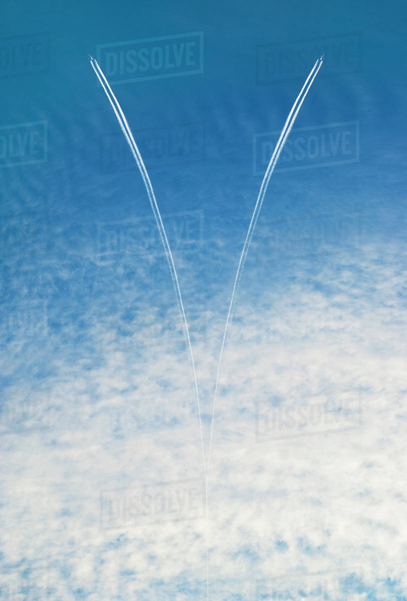 Two airplanes and vapor trails in the sky - Stock Photo - Dissolve