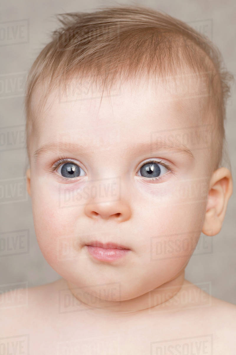 A baby boy staring blankly off camera - Royalty-free Stock Photo | Dissolve