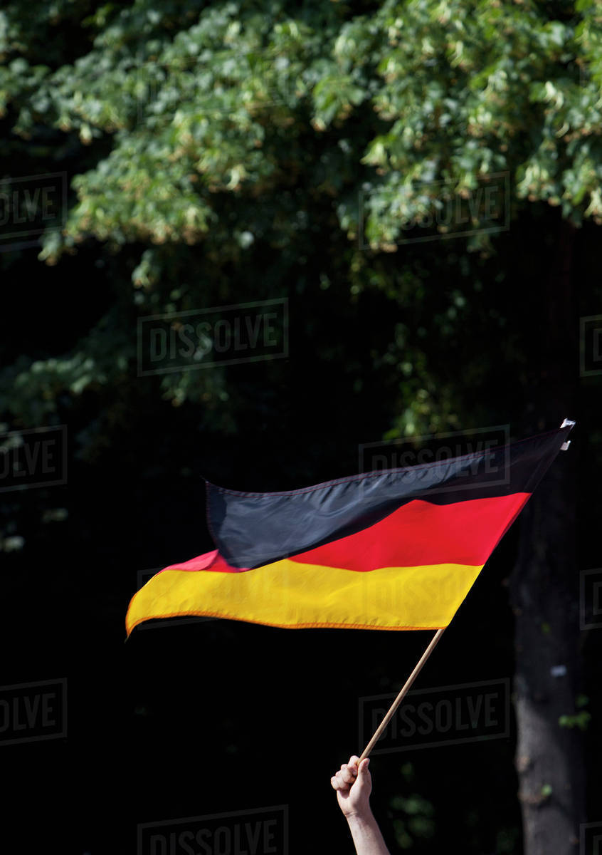 Detail of a person waving a German flag - Royalty-free Stock Photo ...