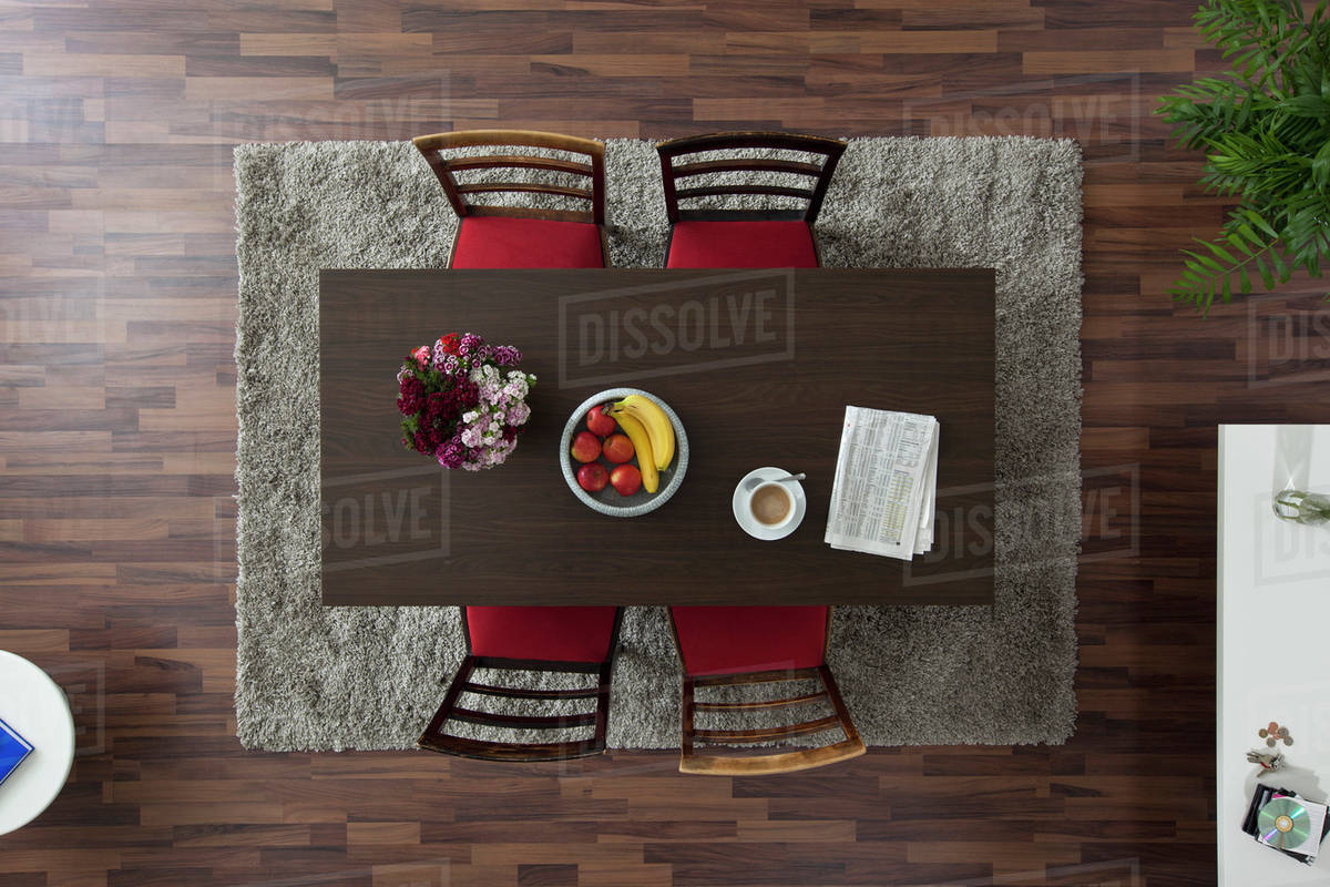 A dining table with a coffee cup and newspaper, overhead view - Royalty ...