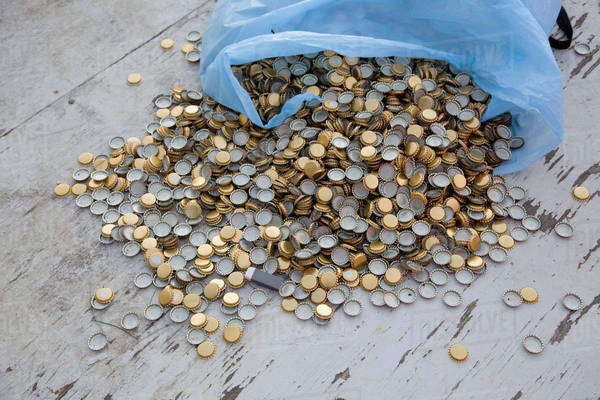 Many bottle caps spilling out of a garbage bag - Royalty-free Stock ...