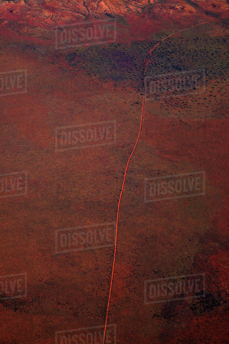 Aerial view of a dirt road positioned in a remote landscape - Stock ...